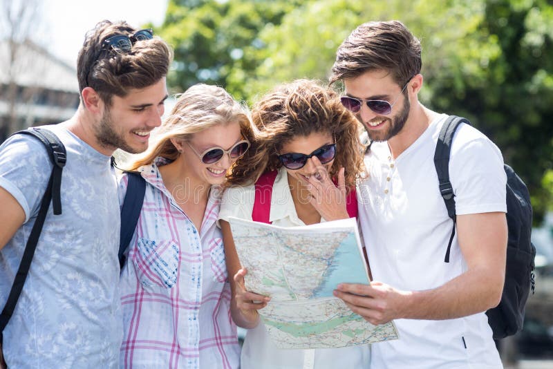 Hip friends checking map stock image. Image of caucasian - 66435377