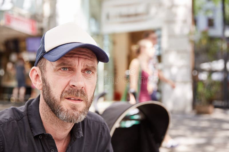 Hipster with Beard and Baseball Cap Sitting in a Street Cafe Stock ...