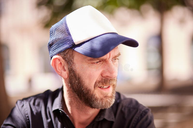 Hipster with Beard and Baseball Cap Sitting in a Street Cafe Stock ...