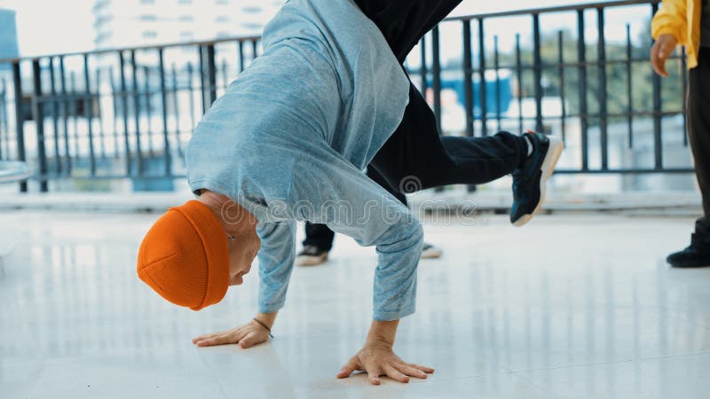 Hipster Doing Head Spin while Surrounded by Multicultural Friends ...