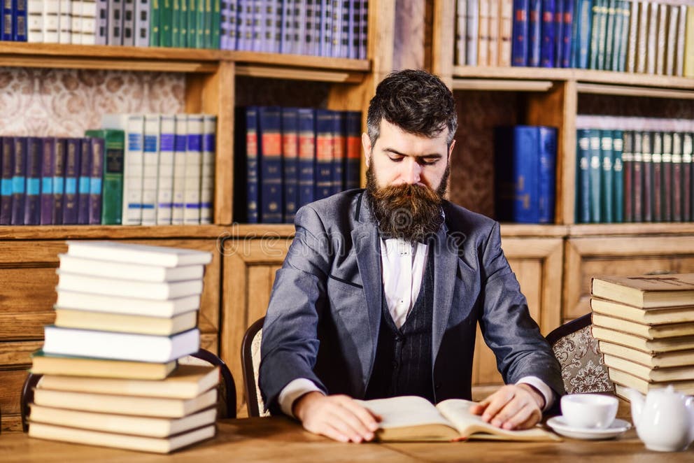 Hipster and Education Concept. Hipster Reading Book in Library Stock ...