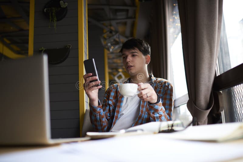 Hipster Guy Sending Text Message with Mobile Phone Device. Student ...