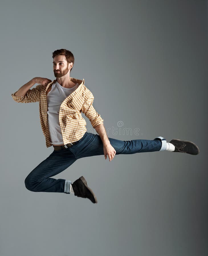 Side View of a Young Fashion Man in Leather Jacket Jumping Stock Photo ...