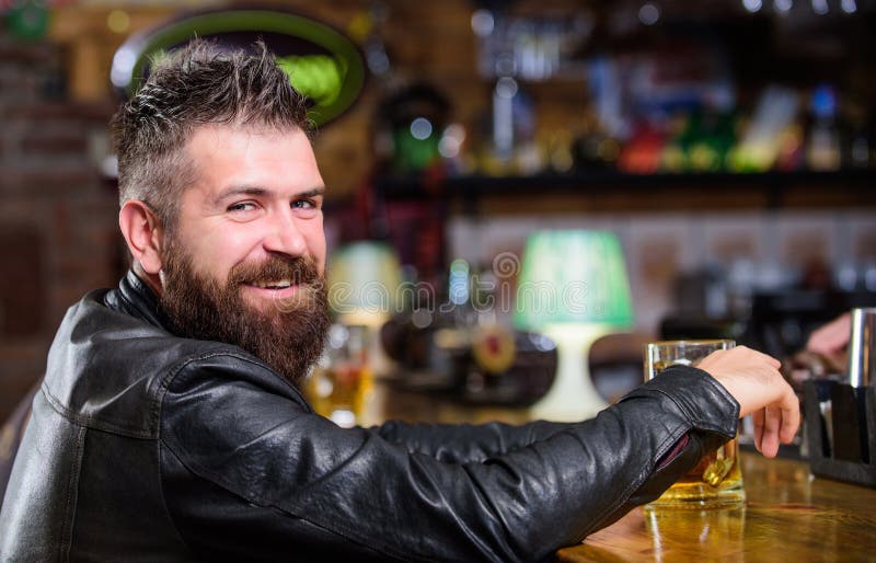 Hipster Relaxing at Bar with Beer. Brutal Hipster Bearded Man Sit at ... Hipster Relaxing at Bar with Beer. Brutal Hipster Bearded Man Sit at ...