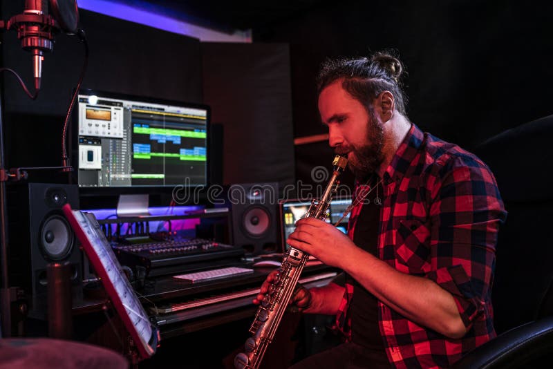 Hipster Withe Young Man is Playing on Musical Instrument in the Studio ...