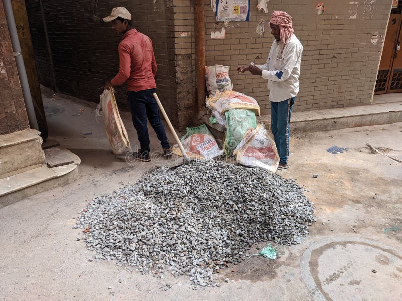 2 Men are Working Around a Pile of Stones (Press Photograph) Editorial ...