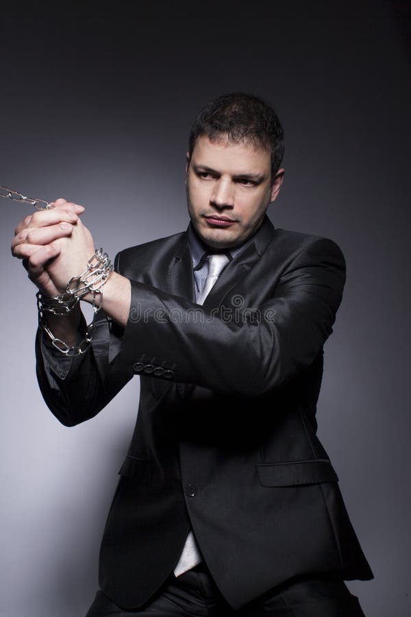 His hands are in chains stock photo. Image of grey, people - 65793620