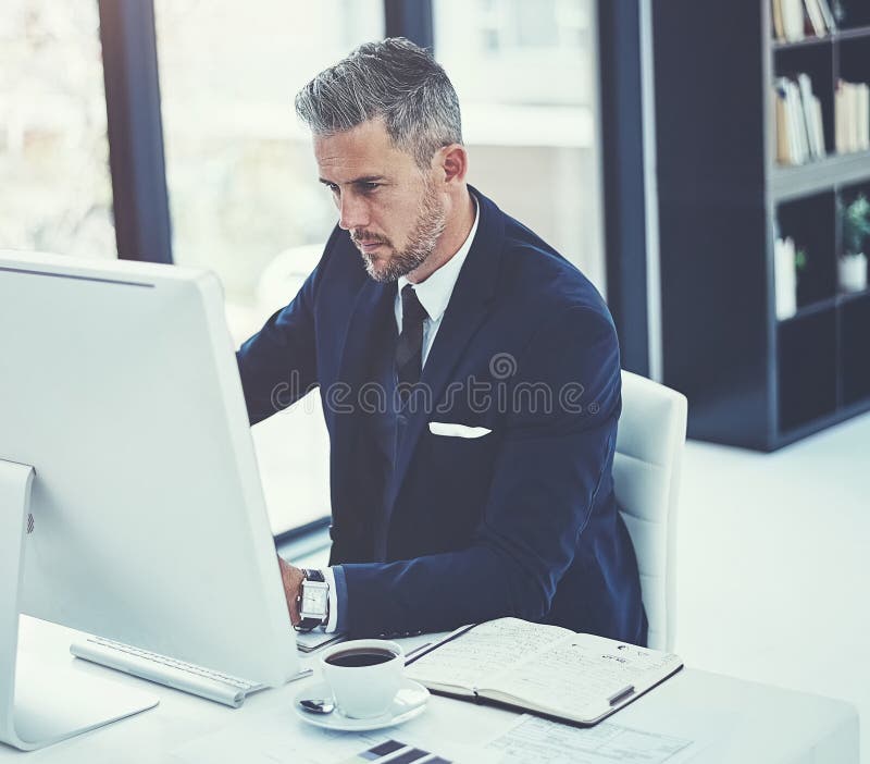 His Hard Work Got Him Here. a Mature Businessman Using a Computer at ...