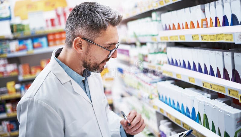 His Pharmacy Has the Best Brands. a Mature Pharmacist Doing Inventory ...