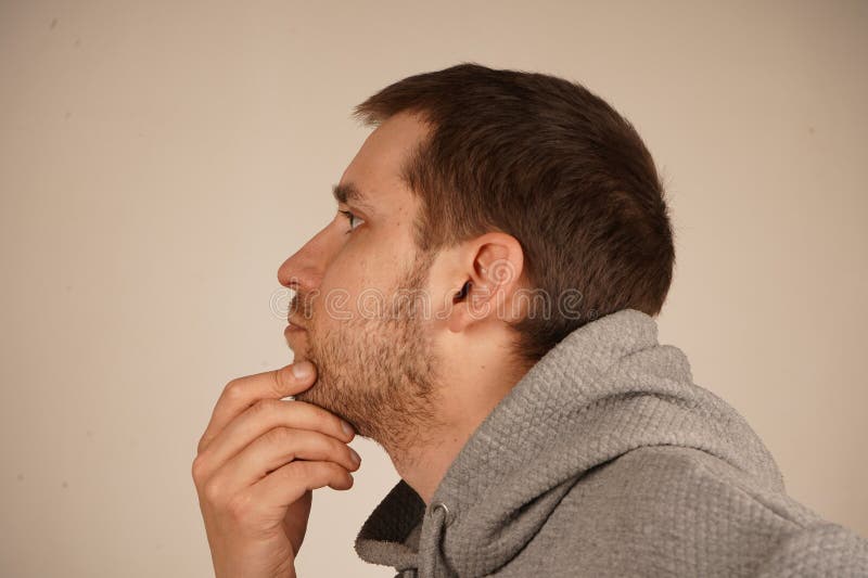 His Serious Expression Reflects a Moment of Deep Thought. the Gesture ...