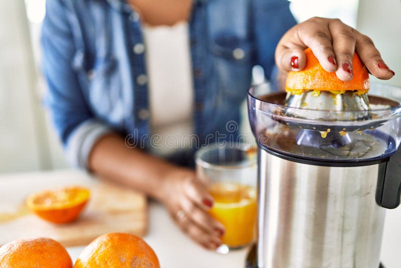 Hispanic Brunette Woman Preparing Orange Juice at the Kitchen Stock ...