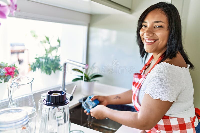 Hispanic Brunette Woman Washing Dishes at the Kitchen Stock Photo ...