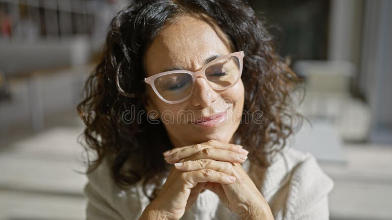 Hispanic Businesswoman Reflects Contentedly in a Bright Modern Office ...