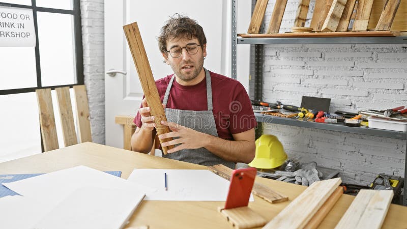 Hispanic Carpenter Examines Wood in a Well-equipped Workshop ...