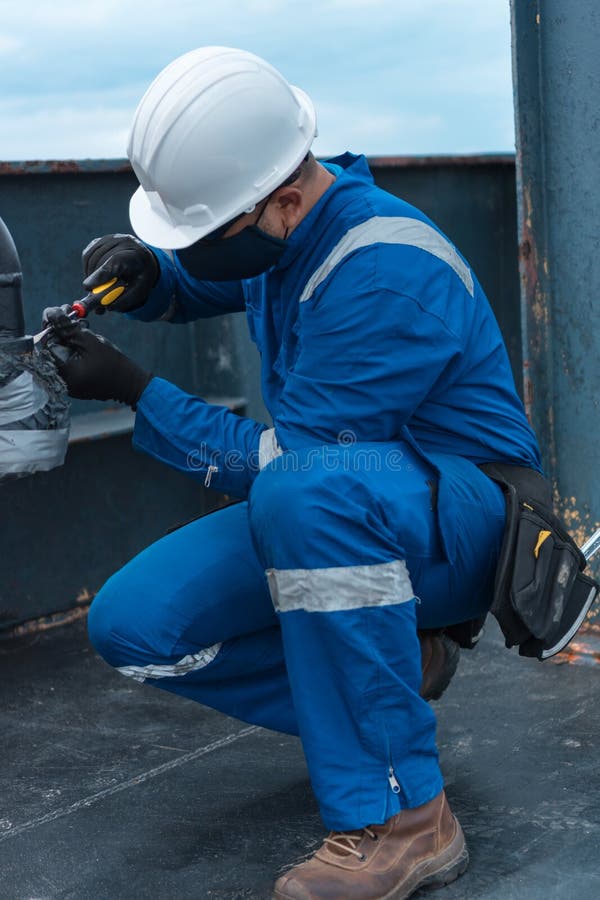 Marine Engineering Officer on the Deck of a Ship. Sailor`s Work Stock ...