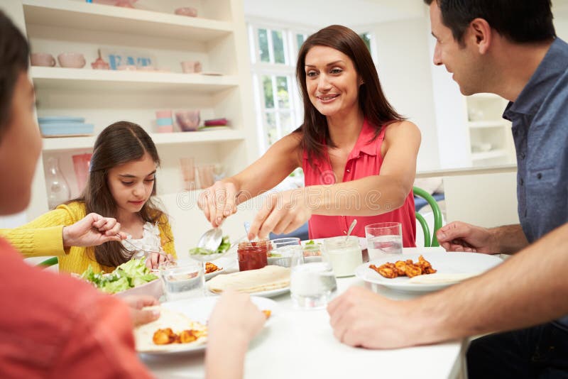 Hispanic Family at Table Eating Meal Together Stock Image - Image of ...