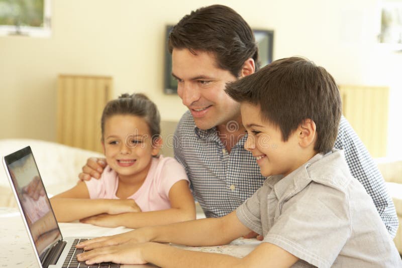 Hispanic Father and Children Using Computer at Home Stock Photo - Image ...