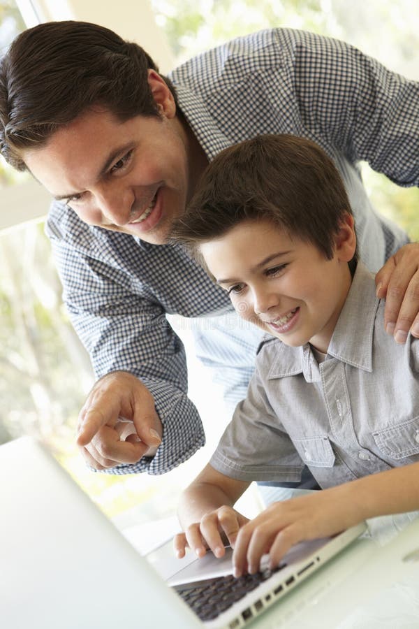 Hispanic Father and Son Using Laptop Stock Photo - Image of desk ...