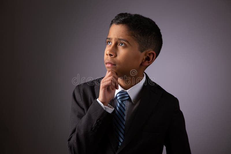 Hispanic Little Boy Deeply Meditating on Complex Subject Stock Image ...