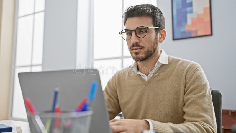 Hispanic Man with Beard and Glasses Focused on Work in Modern Office ...