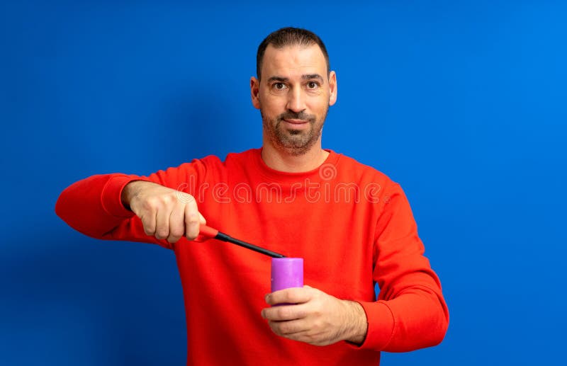 Hispanic Man with a Beard Lighting a Purple Candle with a Kitchen ...