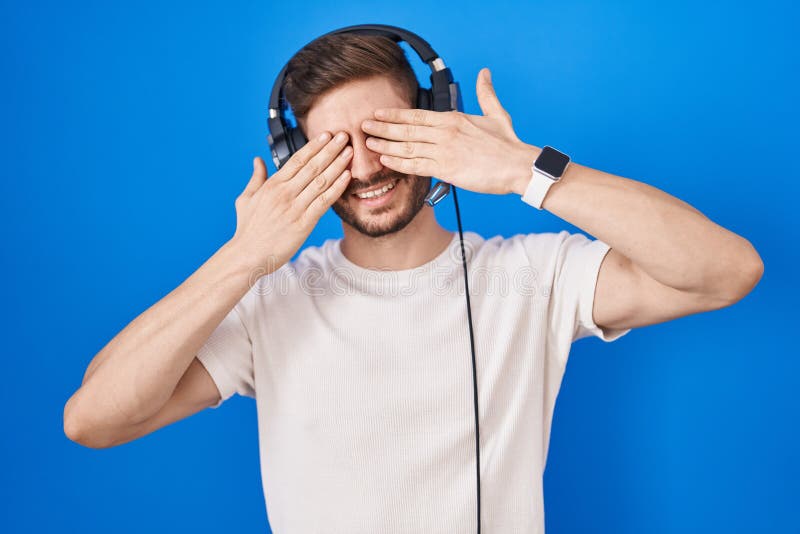 Hispanic Man With Beard Listening To Music Wearing Headphones Covering