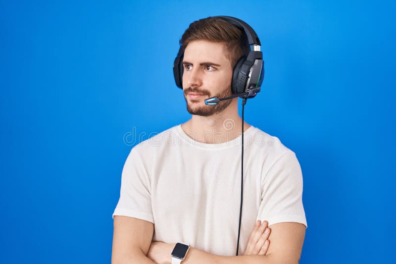 Hispanic Man With Beard Listening To Music Wearing Headphones Looking