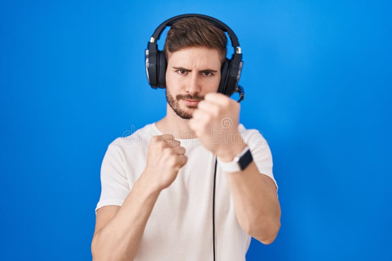 Hispanic Man With Beard Listening To Music Wearing Headphones Ready To