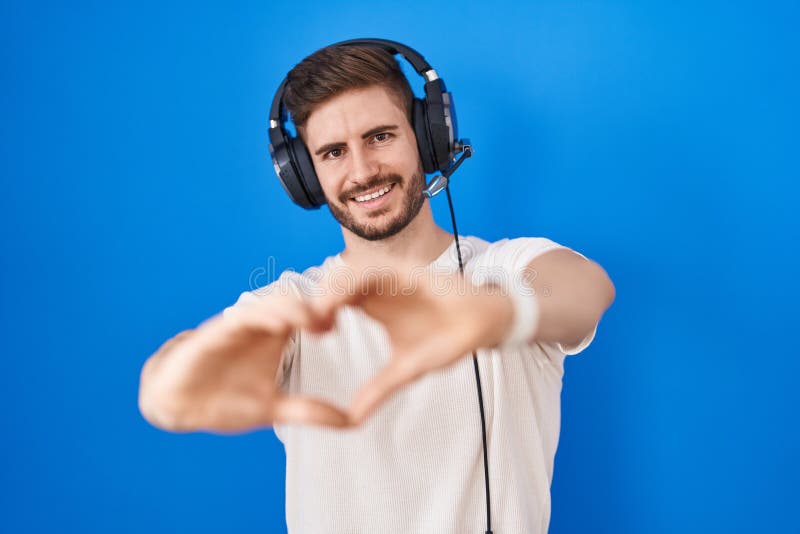 Hispanic Man With Beard Listening To Music Wearing Headphones Smiling