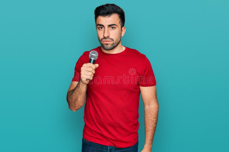 Hispanic Man with Beard Singing Song Using Microphone Thinking Attitude ...