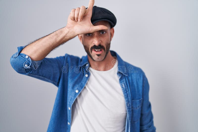 Hispanic Man with Beard Standing Over Isolated Background Making Fun of ...