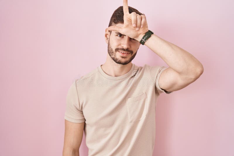 Hispanic Man with Beard Standing Over Pink Background Making Fun of ...