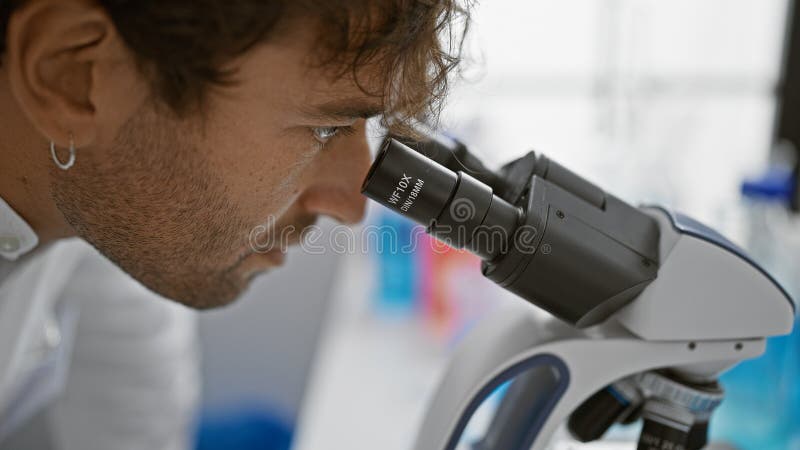 Hispanic Man with Beard Using Microscope in Laboratory Indoors Stock ...