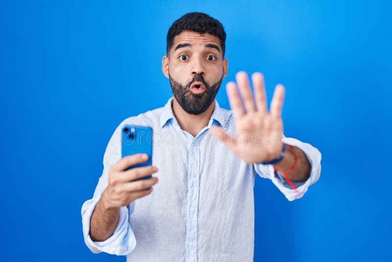Hispanic Man With Beard Using Smartphone Typing Message Doing Stop