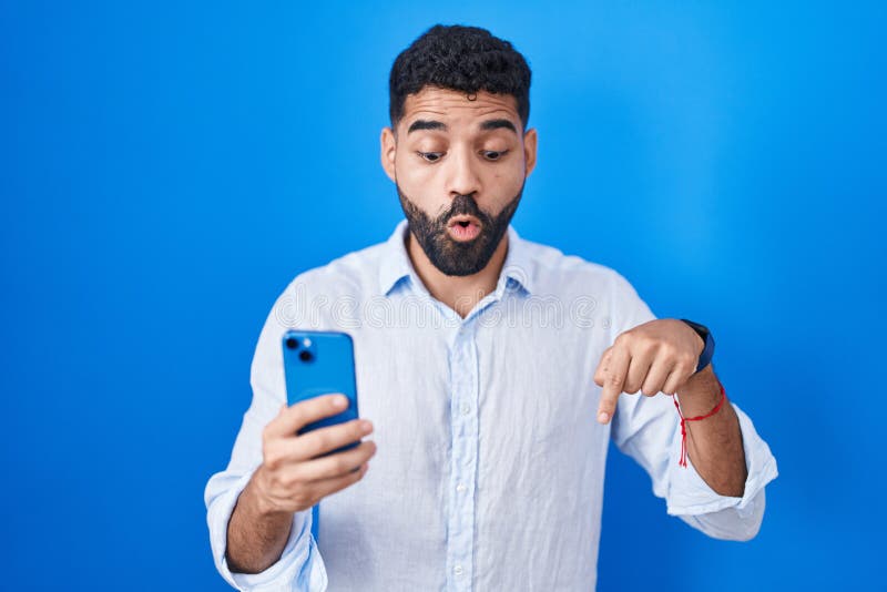 Hispanic Man with Beard Using Smartphone Typing Message Pointing Down ...