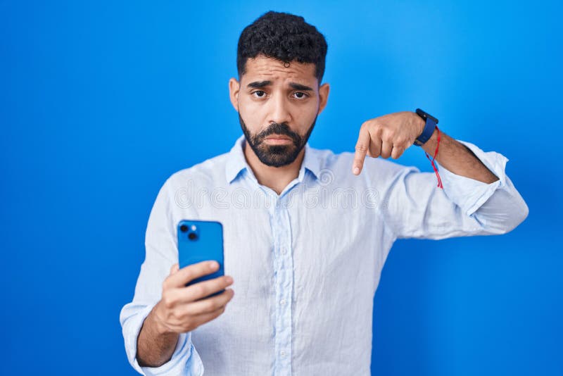 Hispanic Man With Beard Using Smartphone Typing Message Pointing Down