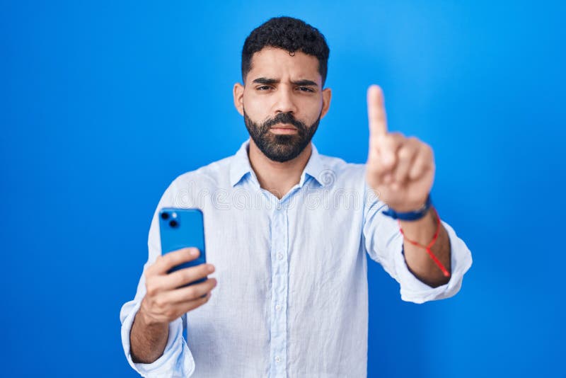 Hispanic Man With Beard Using Smartphone Typing Message Pointing With