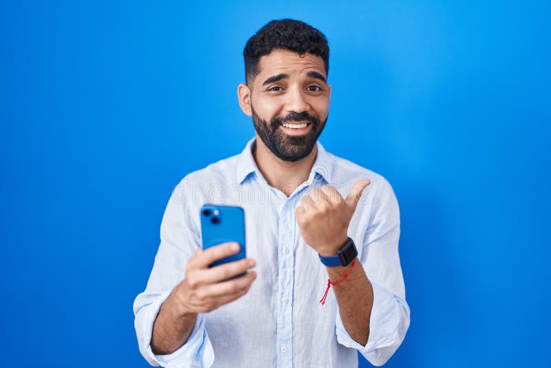 Hispanic Man with Beard Using Smartphone Typing Message Pointing To the ...