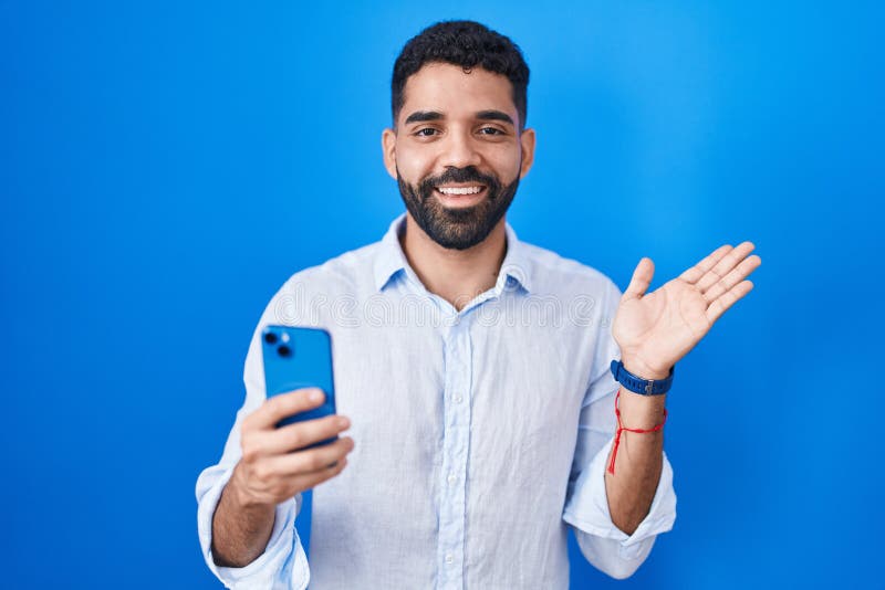 Hispanic Man With Beard Using Smartphone Typing Message Smiling