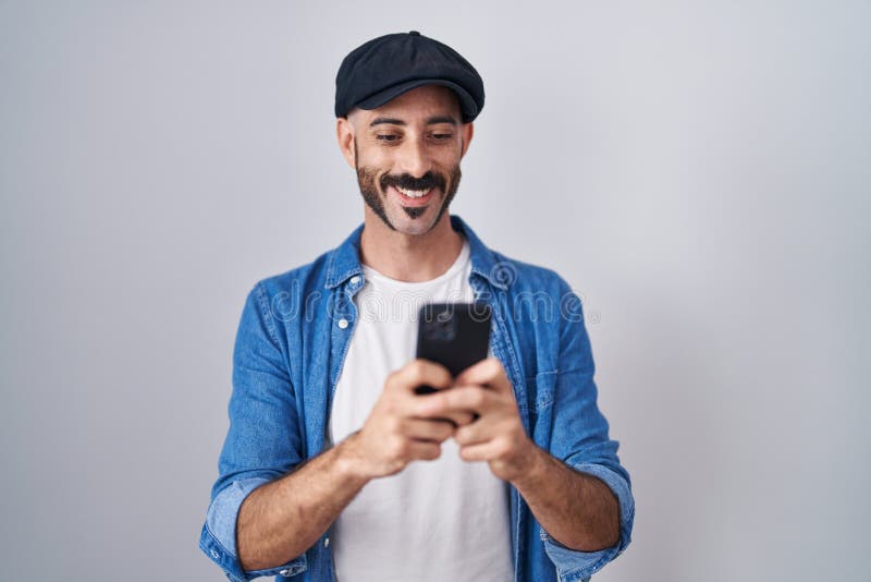 Hispanic Man With Beard Using Smartphone Typing Message Smiling With A