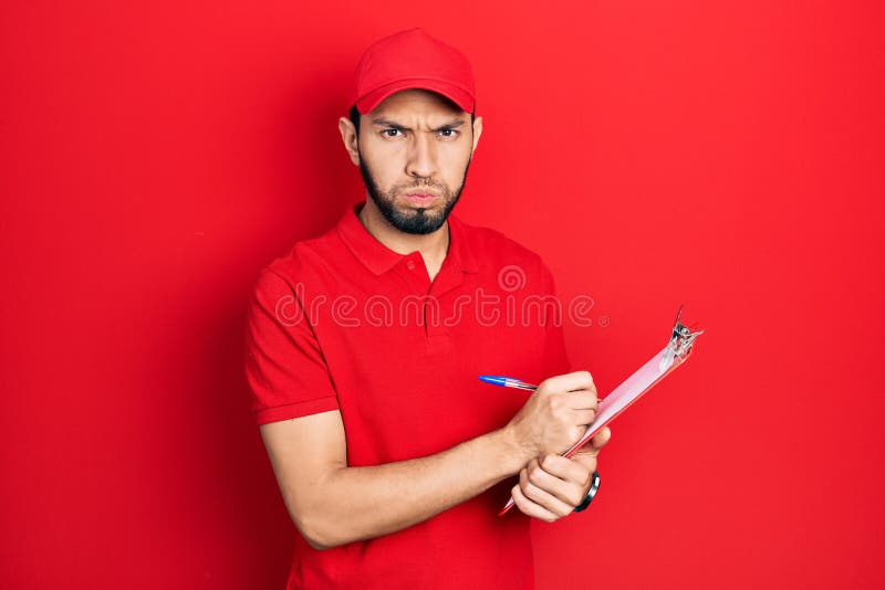 Hispanic Man With Beard Wearing Courier Uniform Holding Clipboard