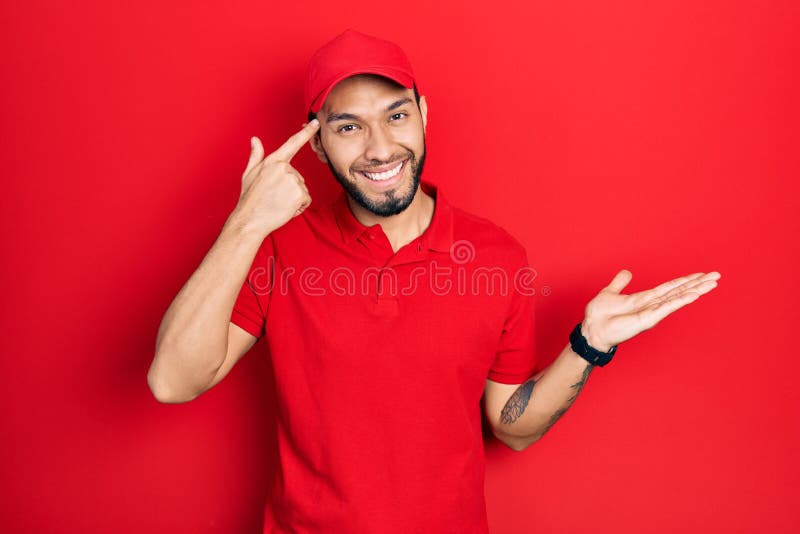 Hispanic Man With Beard Wearing Delivery Uniform And Cap Confused And
