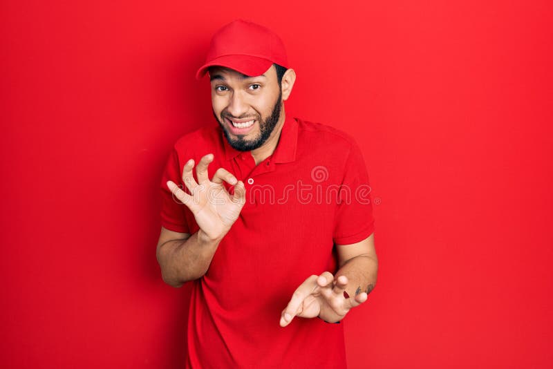 Hispanic Man With Beard Wearing Delivery Uniform And Cap Disgusted