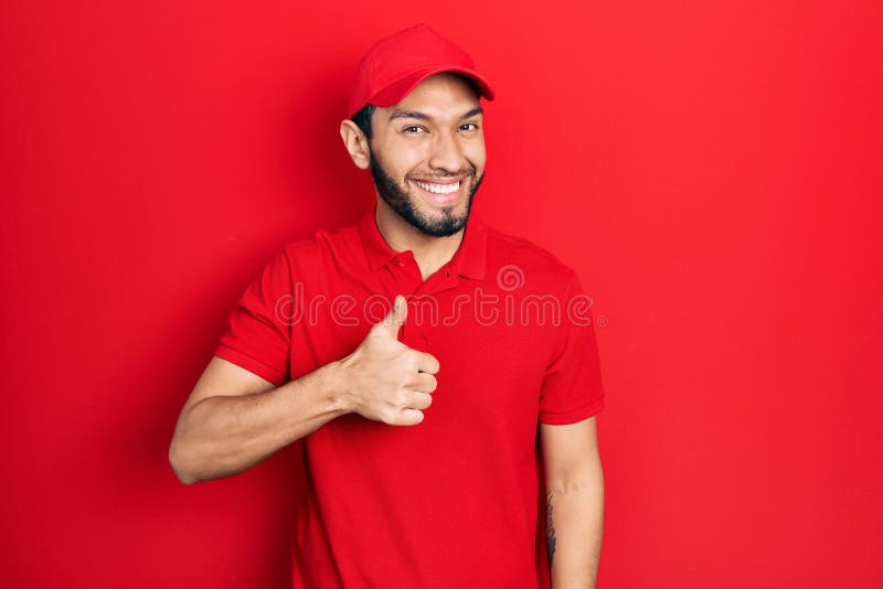 Hispanic Man With Beard Wearing Delivery Uniform And Cap Doing Happy