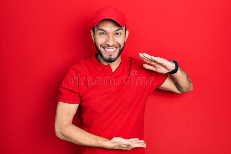Hispanic Man With Beard Wearing Delivery Uniform And Cap Gesturing With