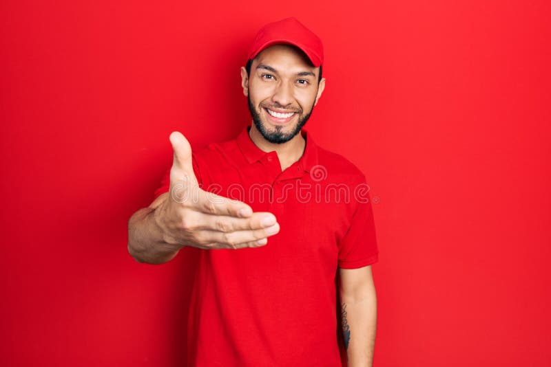 Hispanic Man With Beard Wearing Delivery Uniform And Cap Smiling