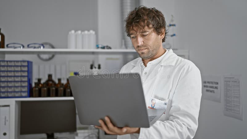 Hispanic Man with Beard Working on Laptop in Laboratory Setting ...