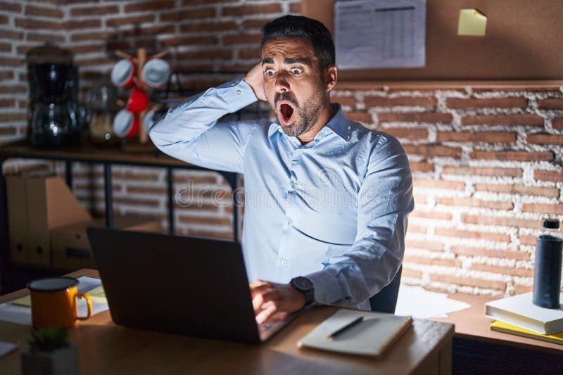 Hispanic Man with Beard Working at the Office at Night Crazy and Scared ...