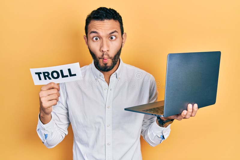 Hispanic Man with Beard Working Using Computer Laptop Holding Banner ...