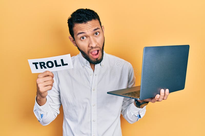 Hispanic Man with Beard Working Using Computer Laptop Holding Banner ...